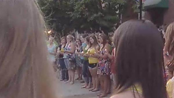 Community shocked by violence holds vigil to remember slain grad ...